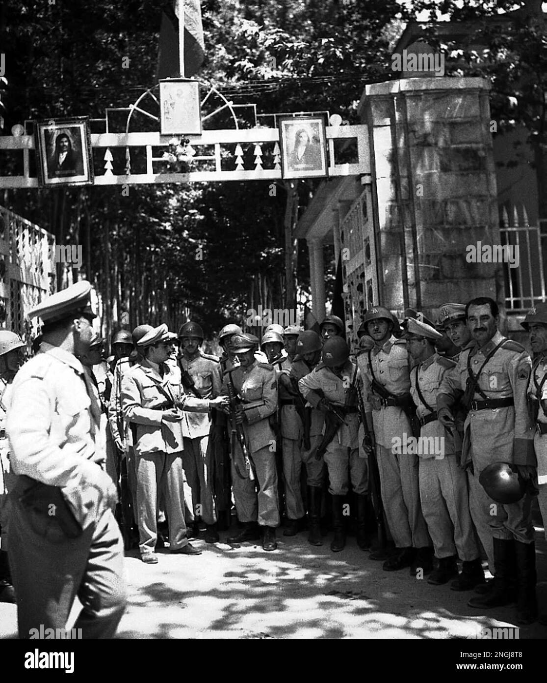 Iranian soldier bunch tightly together outside gate of the shah's ...