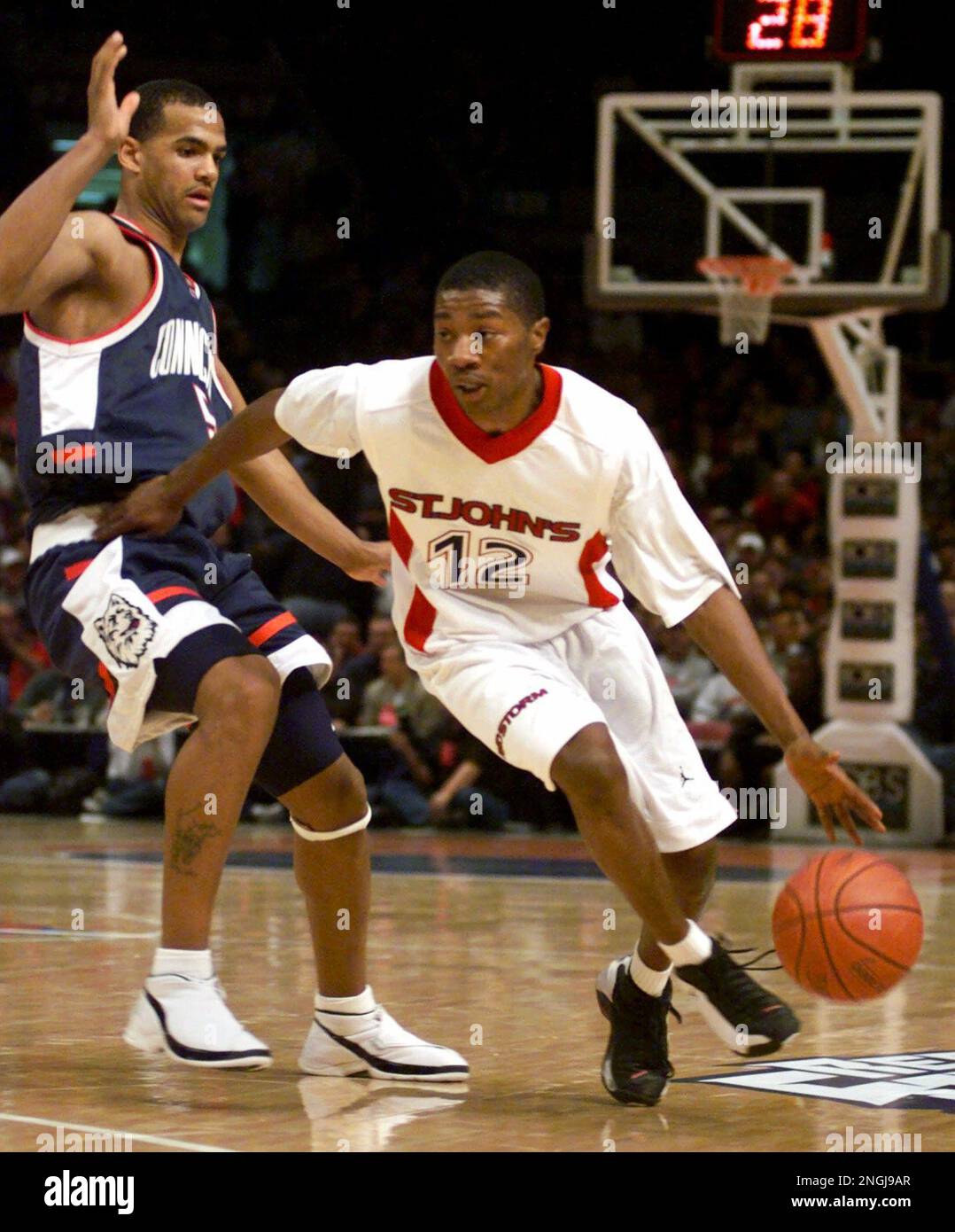 St. John's Erick Barkley (12) takes the ball past Connecticut's Edmund ...