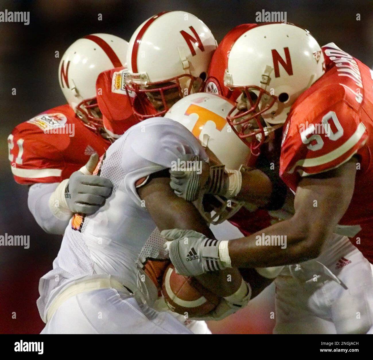 Tennessee's Travis Henry is stopped by Nebraska defensemen (L-R), Mike ...