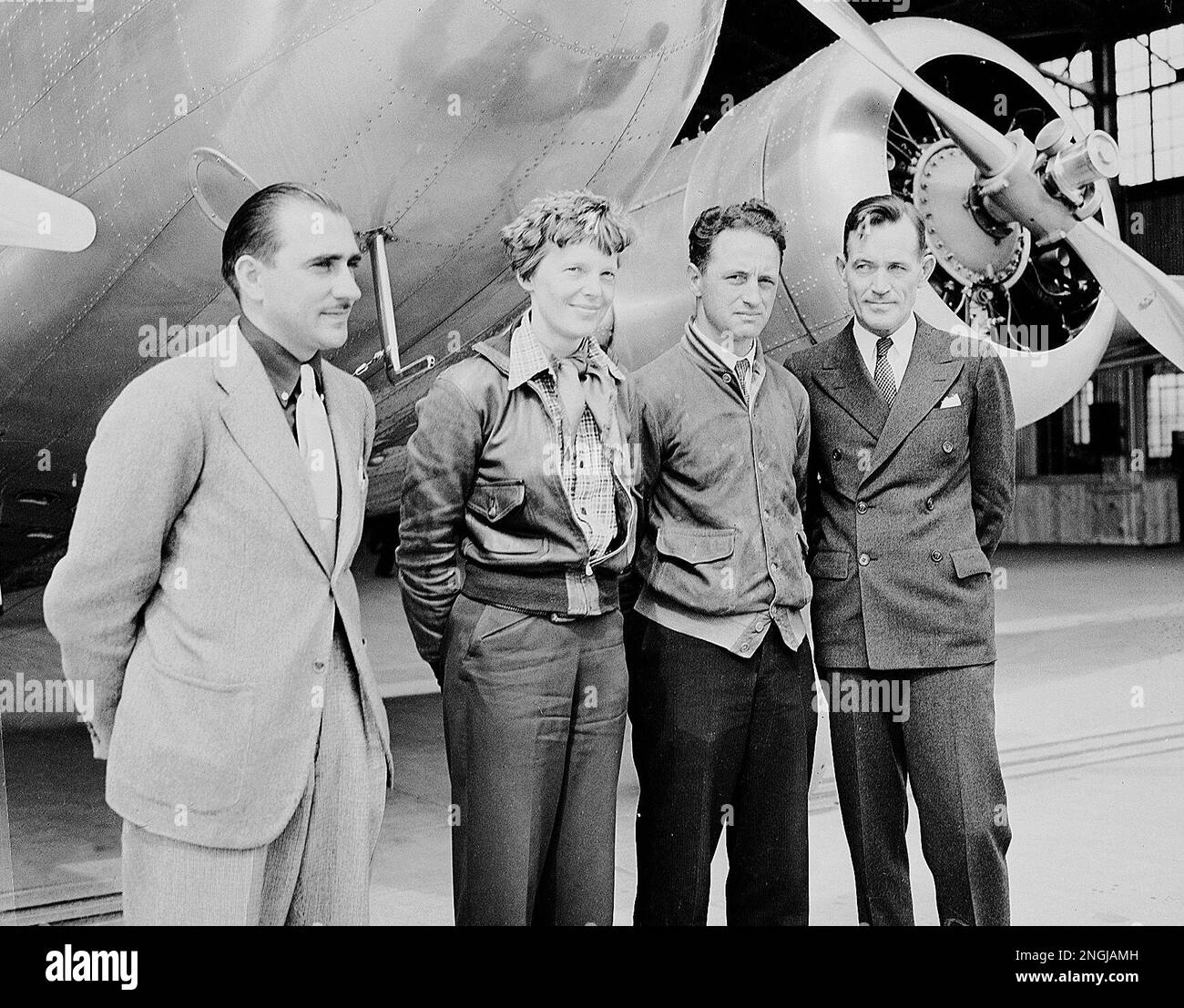 Aviator Amelia Earhart stands with members of her flight team in ...