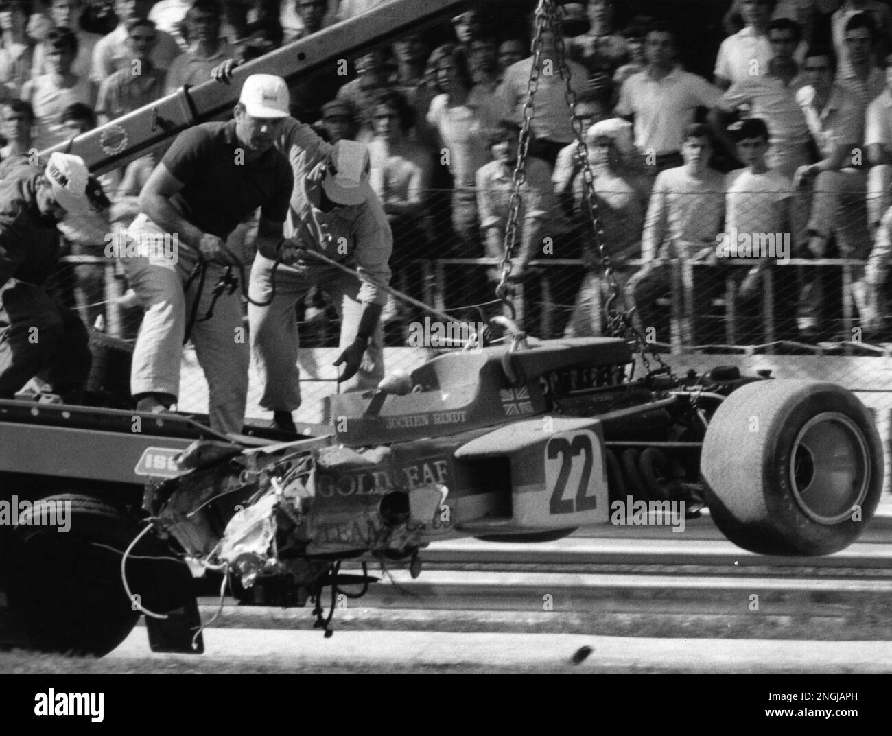 Workers remove the Lotus-Ford off the track after Austrian racing ...