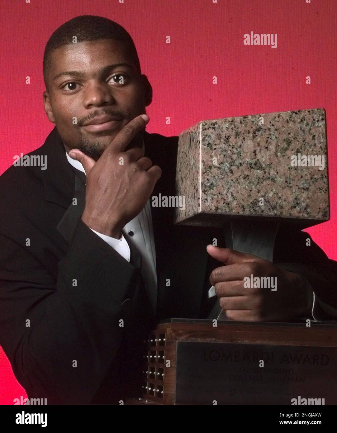 Corey Moore from Virginia Tech poses with the Lombardi Award trophy ...