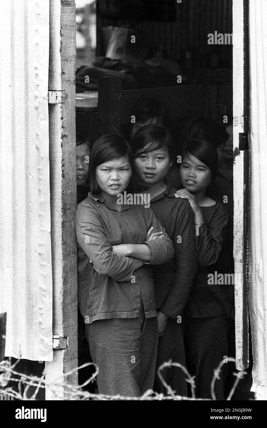 A group of female prisoners-of-war look out from their barracks at Qui ...