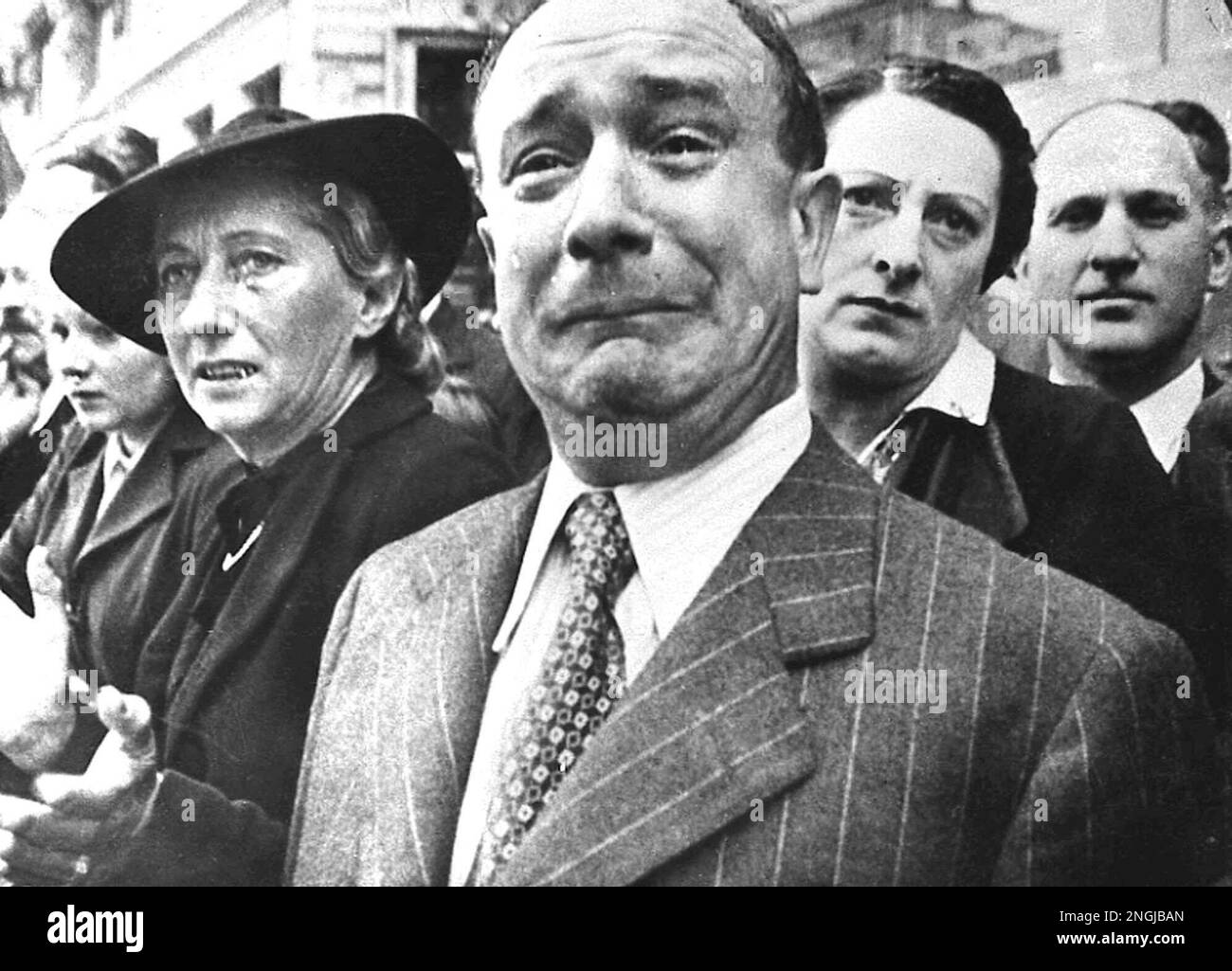In German-occupied France, a Frenchman weeps as spectators watch the ...