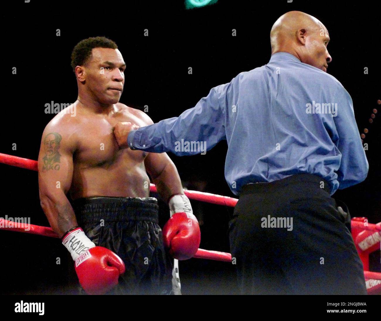 Referee Richard Steele holds back Mike Tyson after separating him from ...