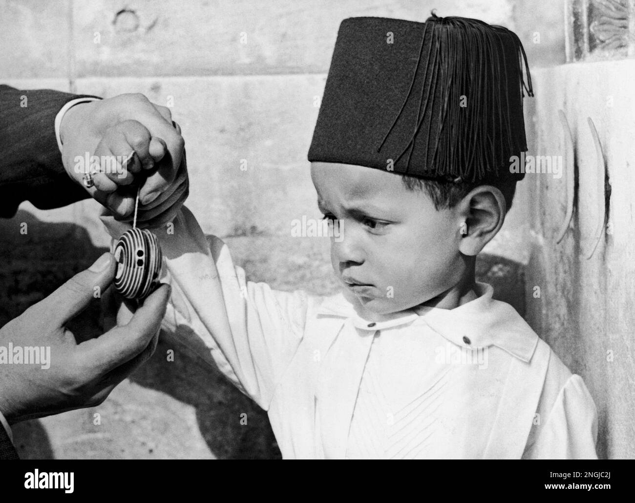 Prince Moulay El Hassan plays with a yo-yo while in Paris with his ...