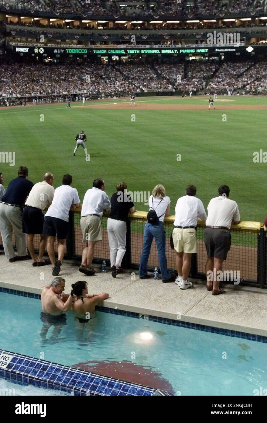 A couple relaxes in the right field swimming pool at Bank One Ballpark ...