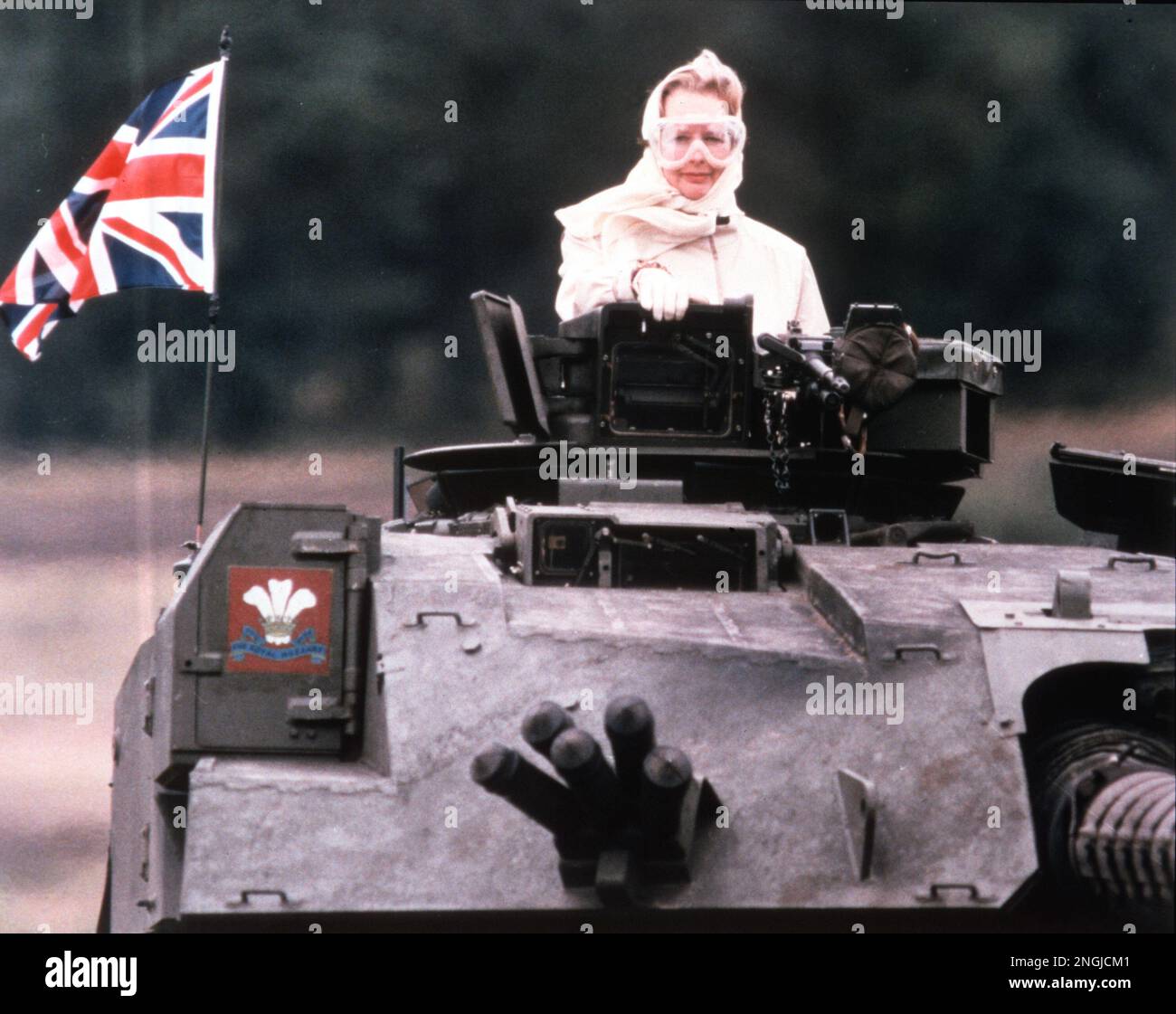 British Prime Minister Margaret Thatcher rides aboard a tank during an ...