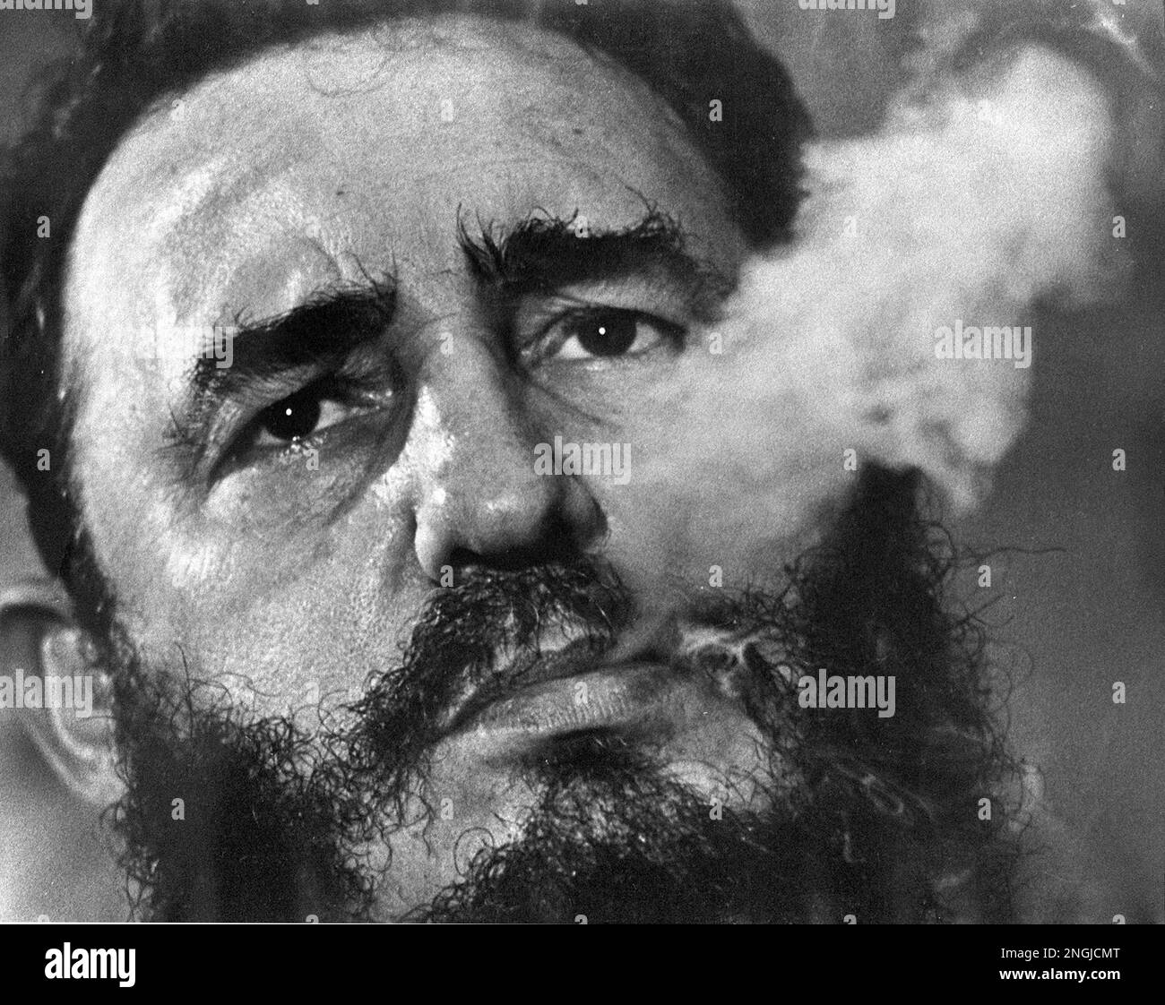 Cuban Prime Minister Fidel Castro exhales cigar smoke during a March ...