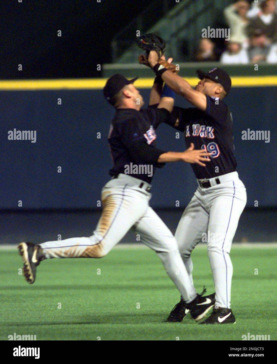 New York Mets outfielder Roger Cedeno, right, gets crossed up with ...