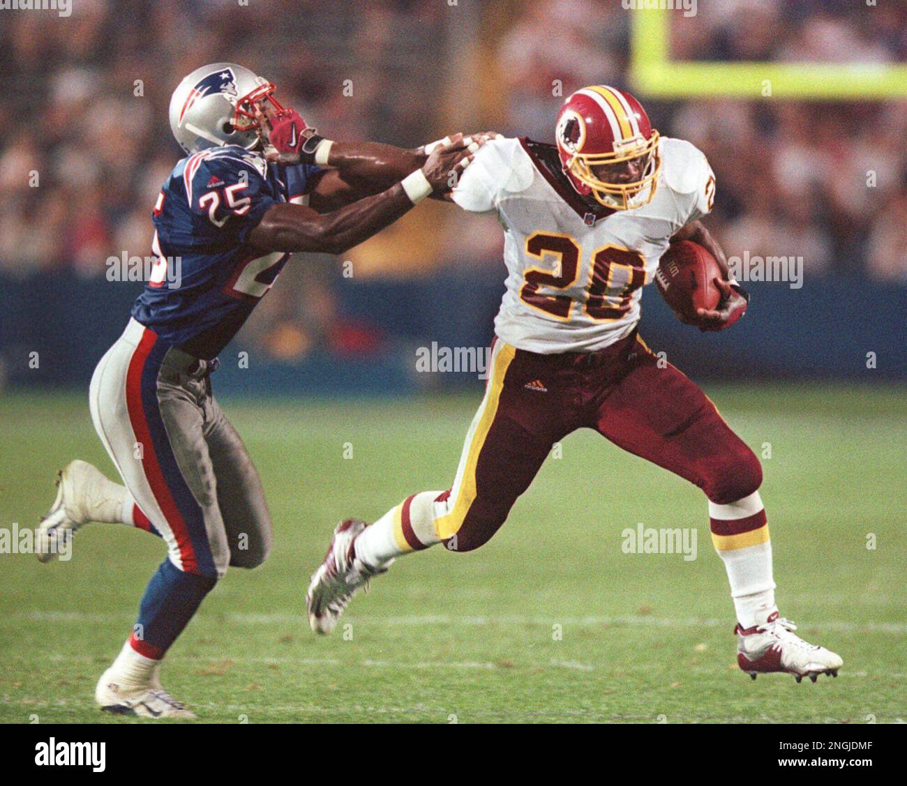 Washington Redskins running back Skip Hicks (20) stiff-arms New England ...