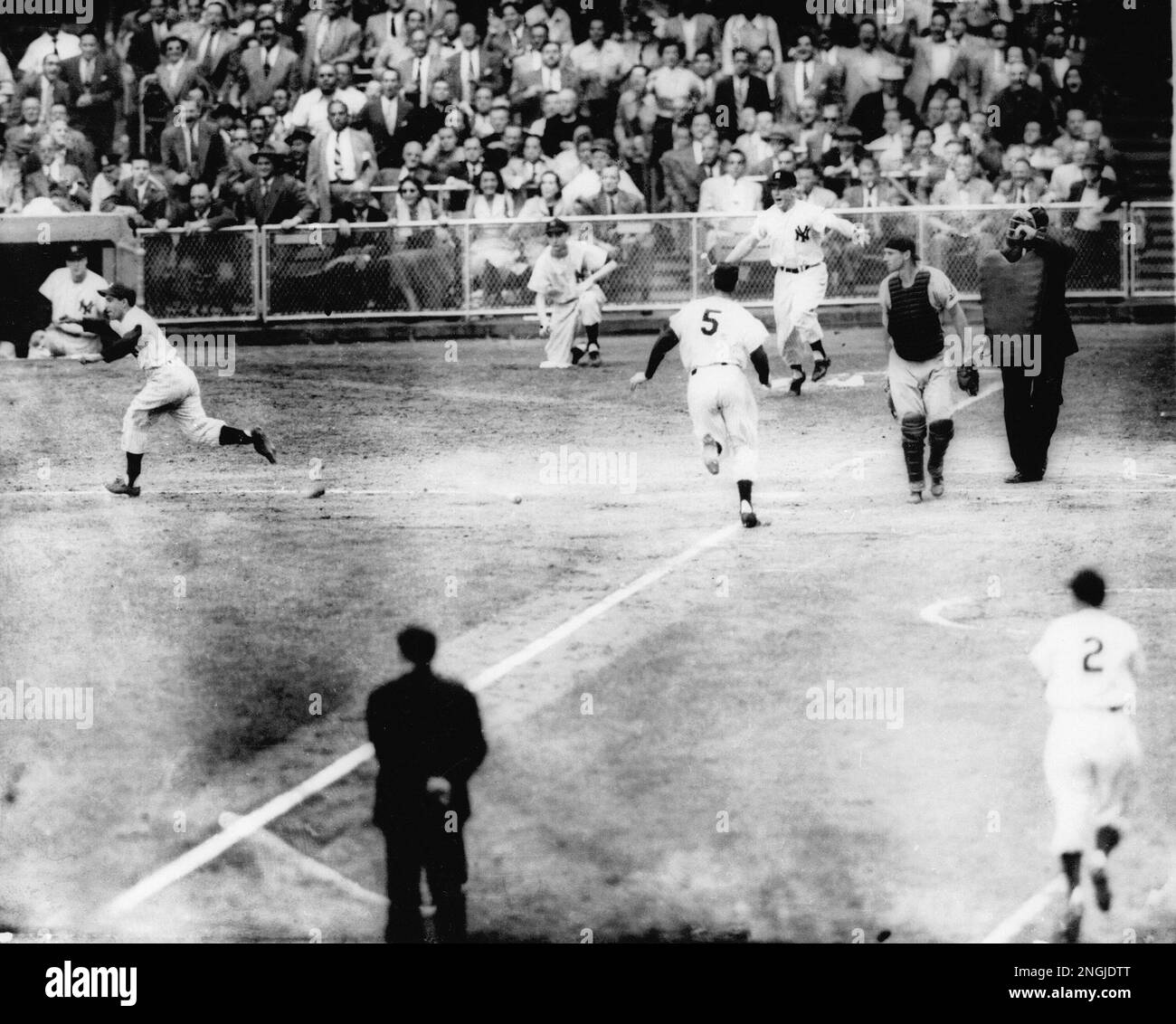 New York Yankees Joe DiMaggio, right, nears home plate with the winning ...