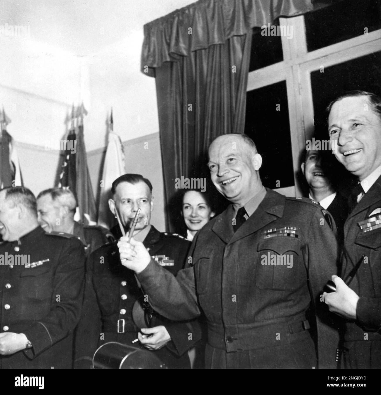 Gen. Dwight D. Eisenhower makes a V for Victory with two pens used for ...