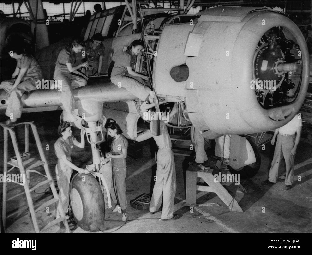 A crew of women work on the final assembly of Vultee Aircraft's ...