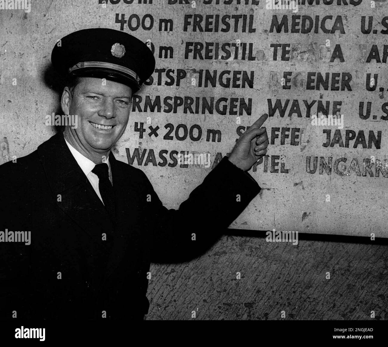 Marshall Wayne points to his name inscribed in bronze at the Olympic ...
