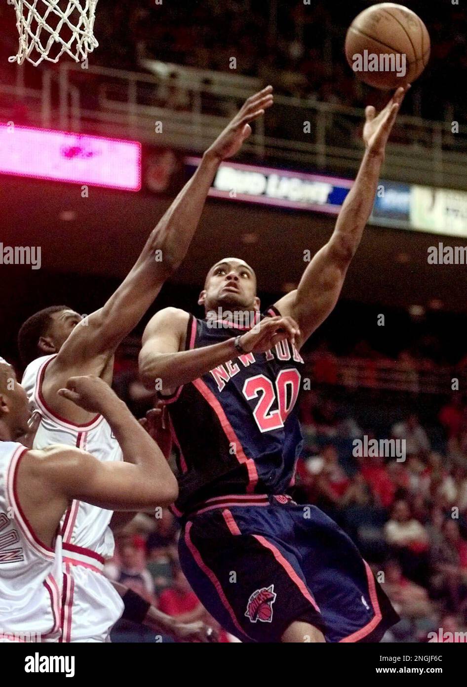 New York Knicks guard Allan Houston (20) goes over the top of Miami ...