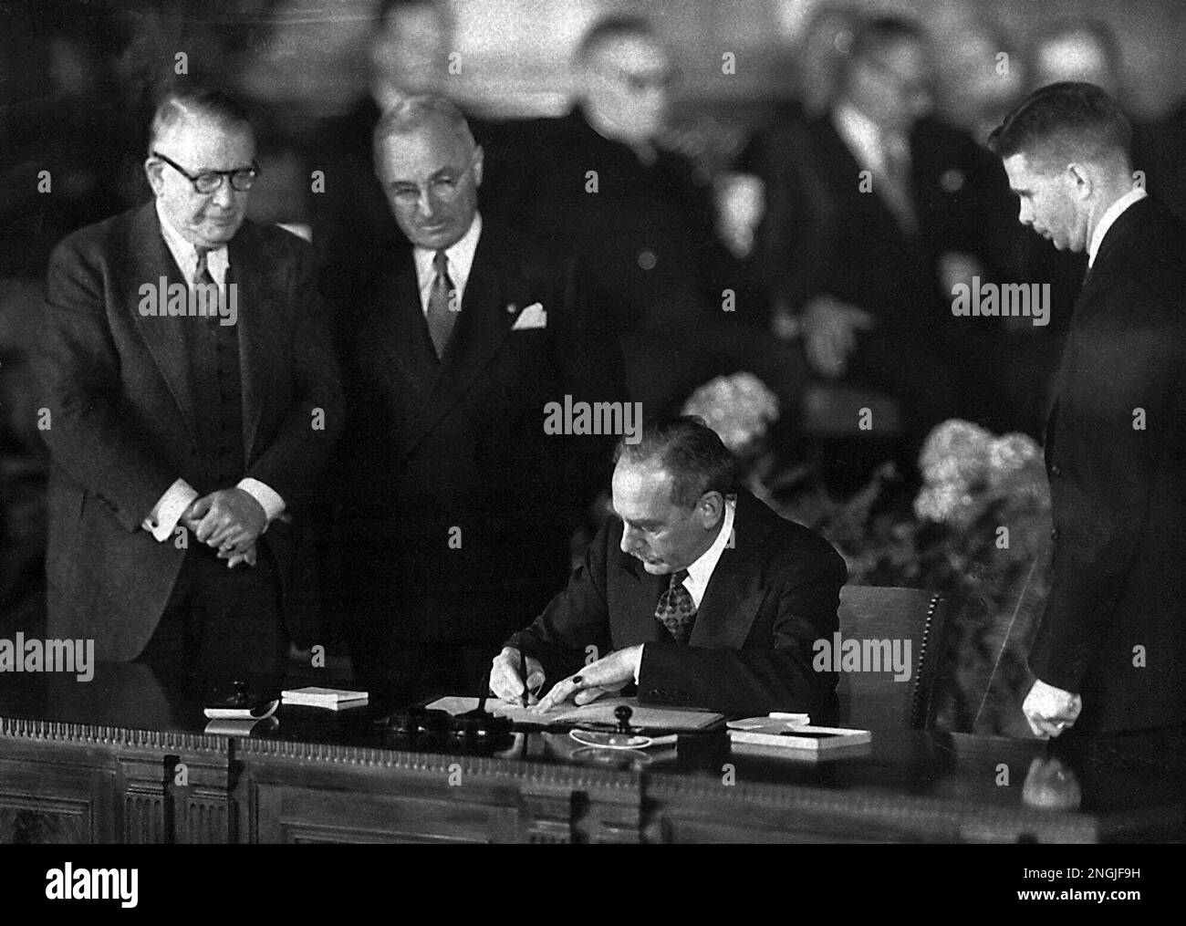 U.S. Secretary of State Dean Acheson signs the Atlantic defense treaty ...