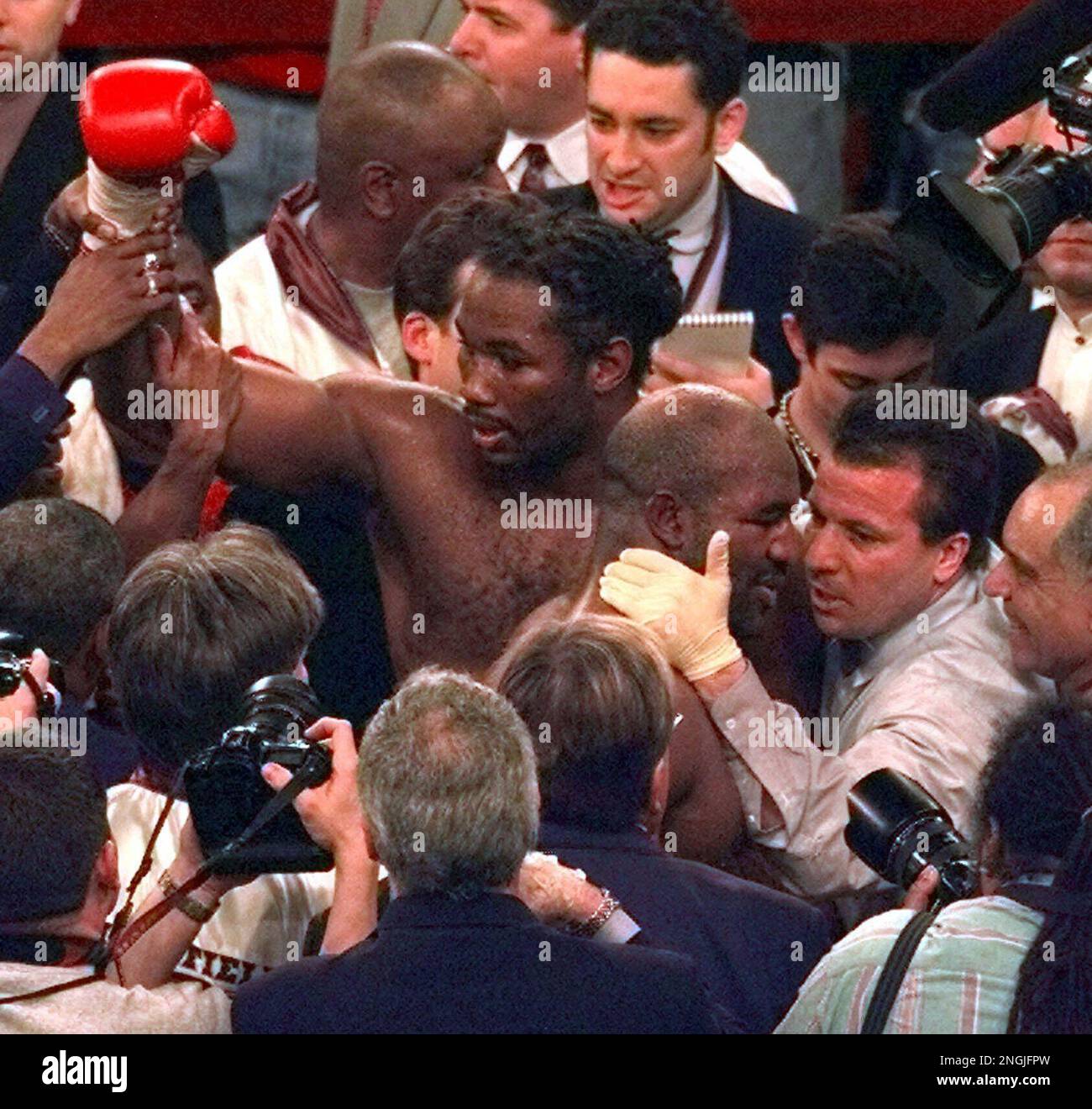 Britain's Lennox Lewis holds up his arm immediately following the fight ...