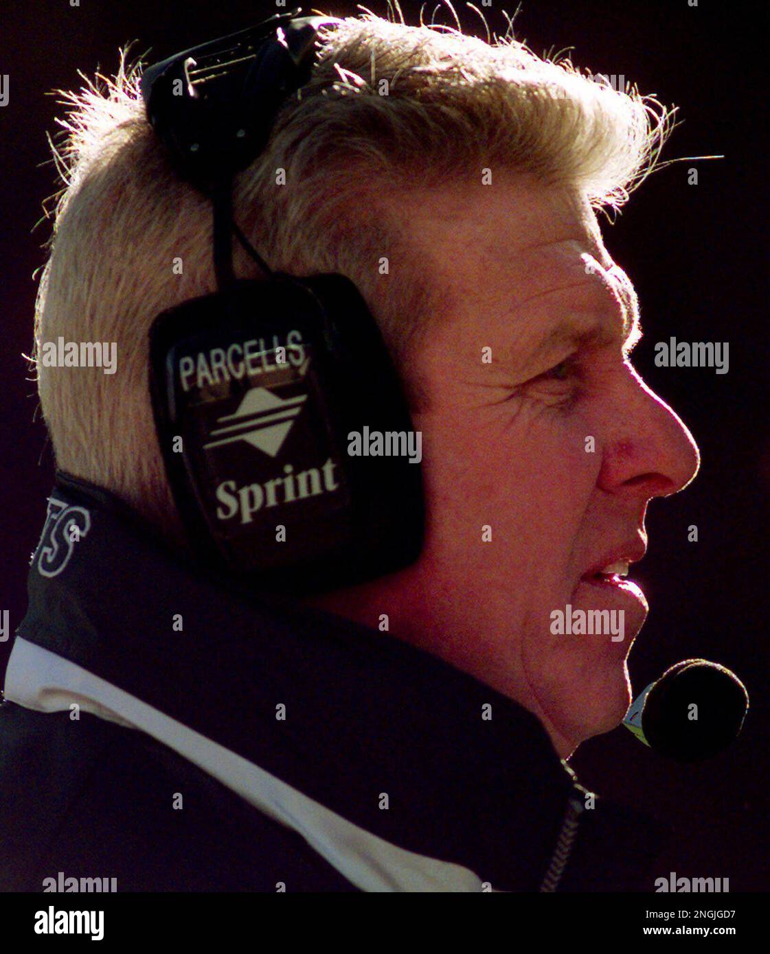 New York Jets head coach Bill Parcells is rim lit in the late afternoon ...