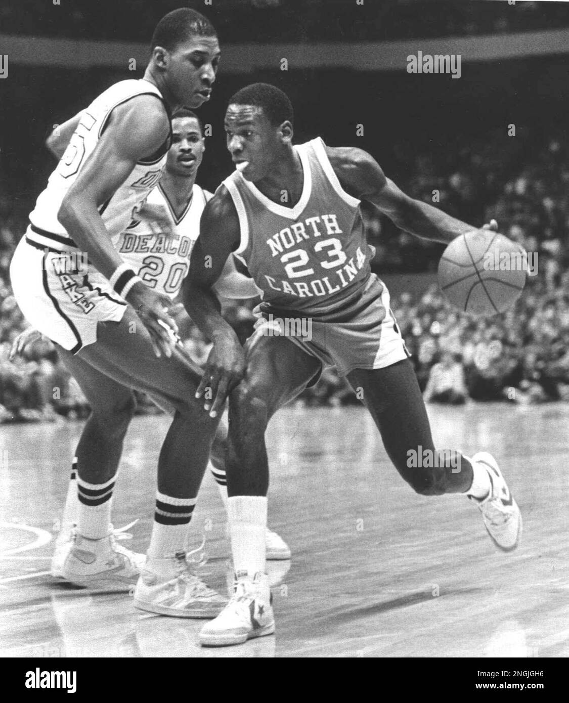 North Carolina's Michael Jordan (23) drives around the defense of Wake ...