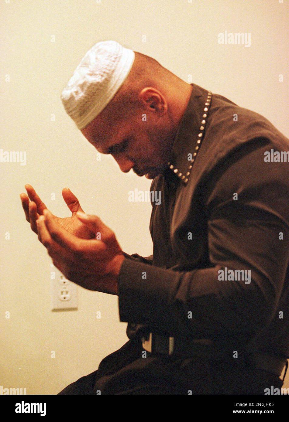 Boxer Mike Tyson is seen in prayer at a mosque of the Boston Area ...