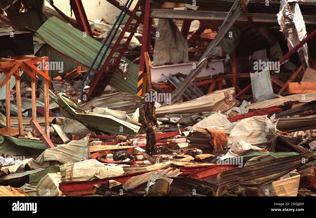 An American soldier walks through the rubble of a U.S. military ...