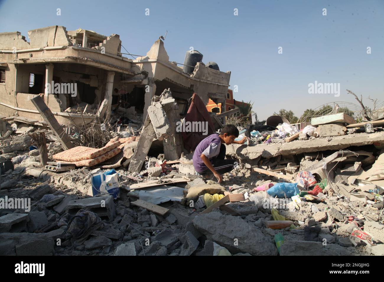 Gaza, Palestine. Two children sit on what remains of their destroyed ...