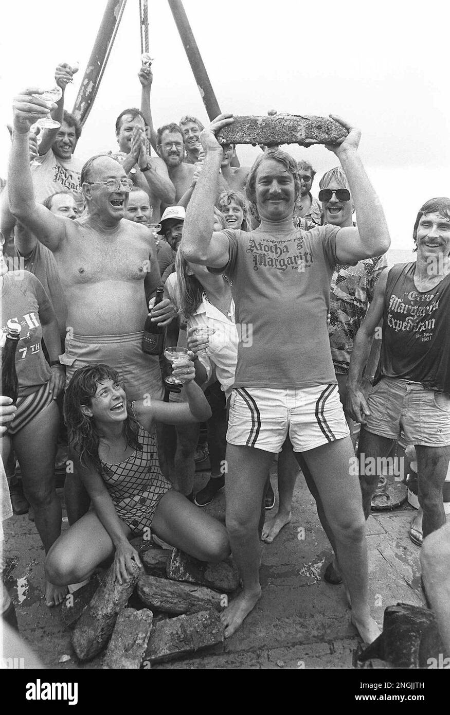 Treasure hunter Mel Fisher, left, holding champagne bottle, toasts as ...