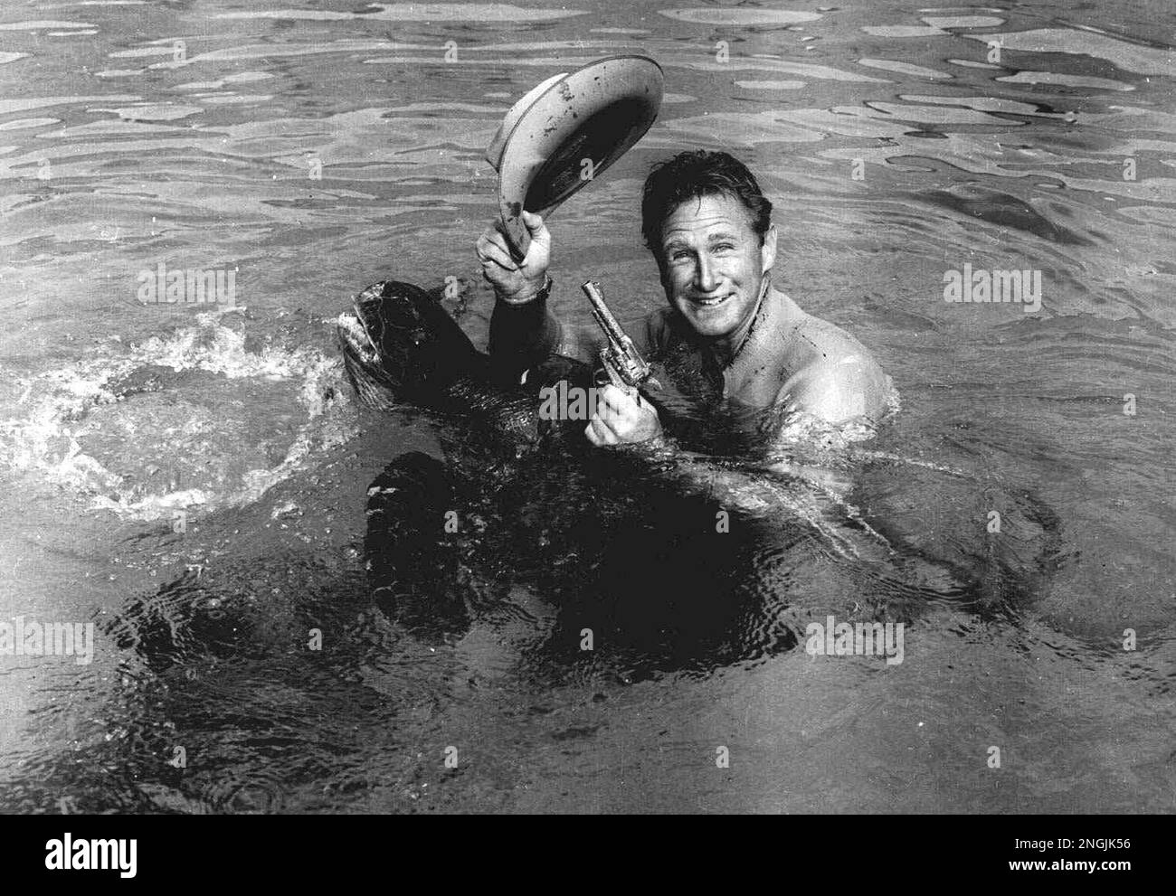 Actor Lloyd Bridges tips his hat while riding a sea turtle on June 6 ...