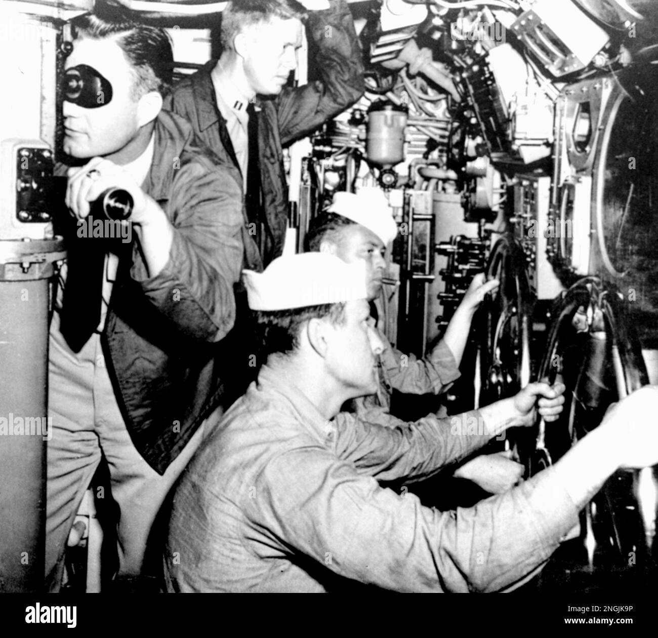 Lt. Jimmy Carter peers at instruments on submarine USS K-1 in a 1952 ...