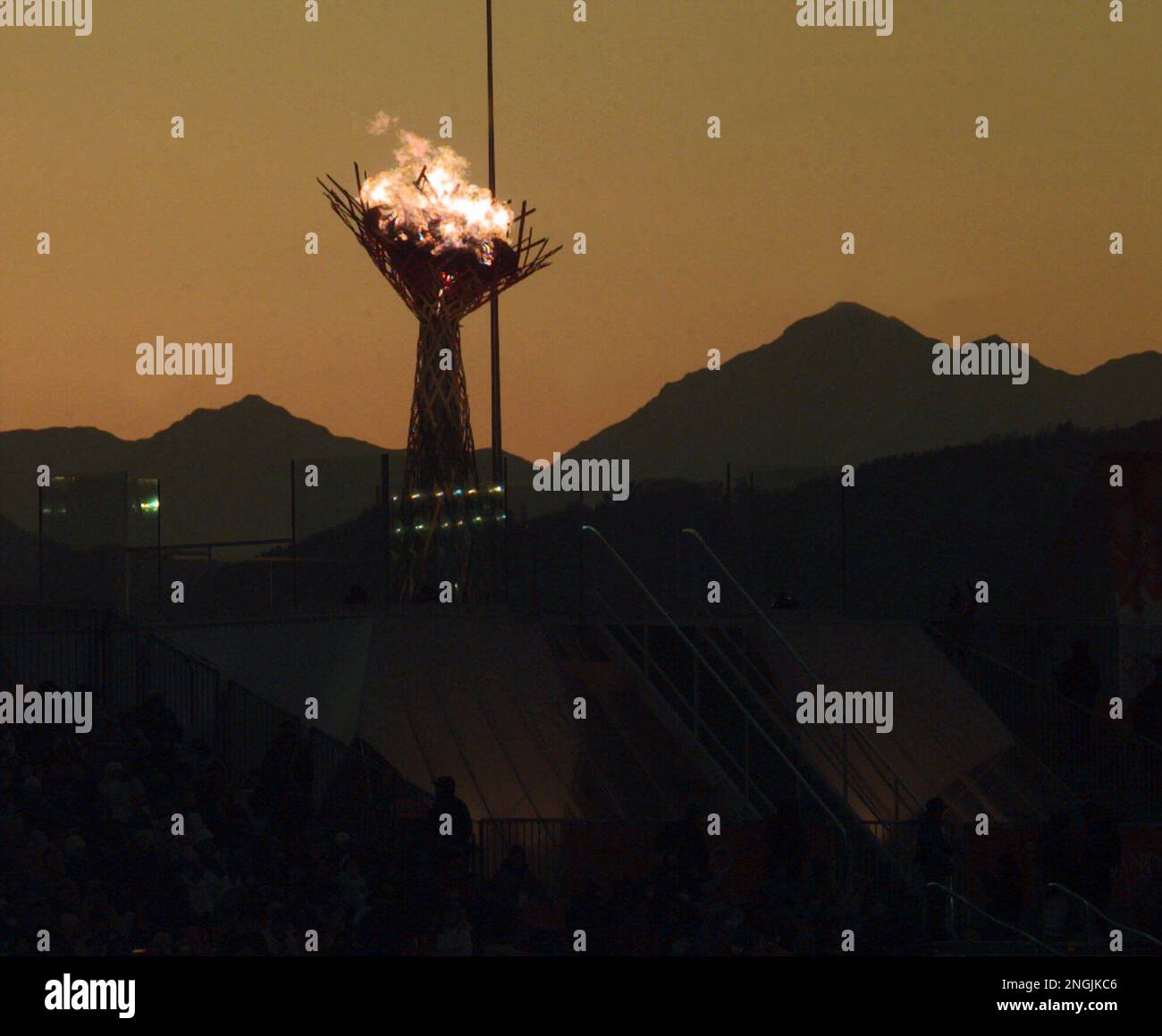 The Olympic flame burns as the sun sets over the Japanese Alps prior to ...