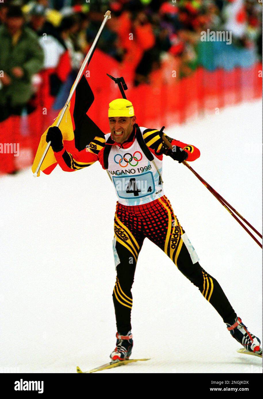 Germany's anchor Frank Luck carries his nation's flag to win the ...