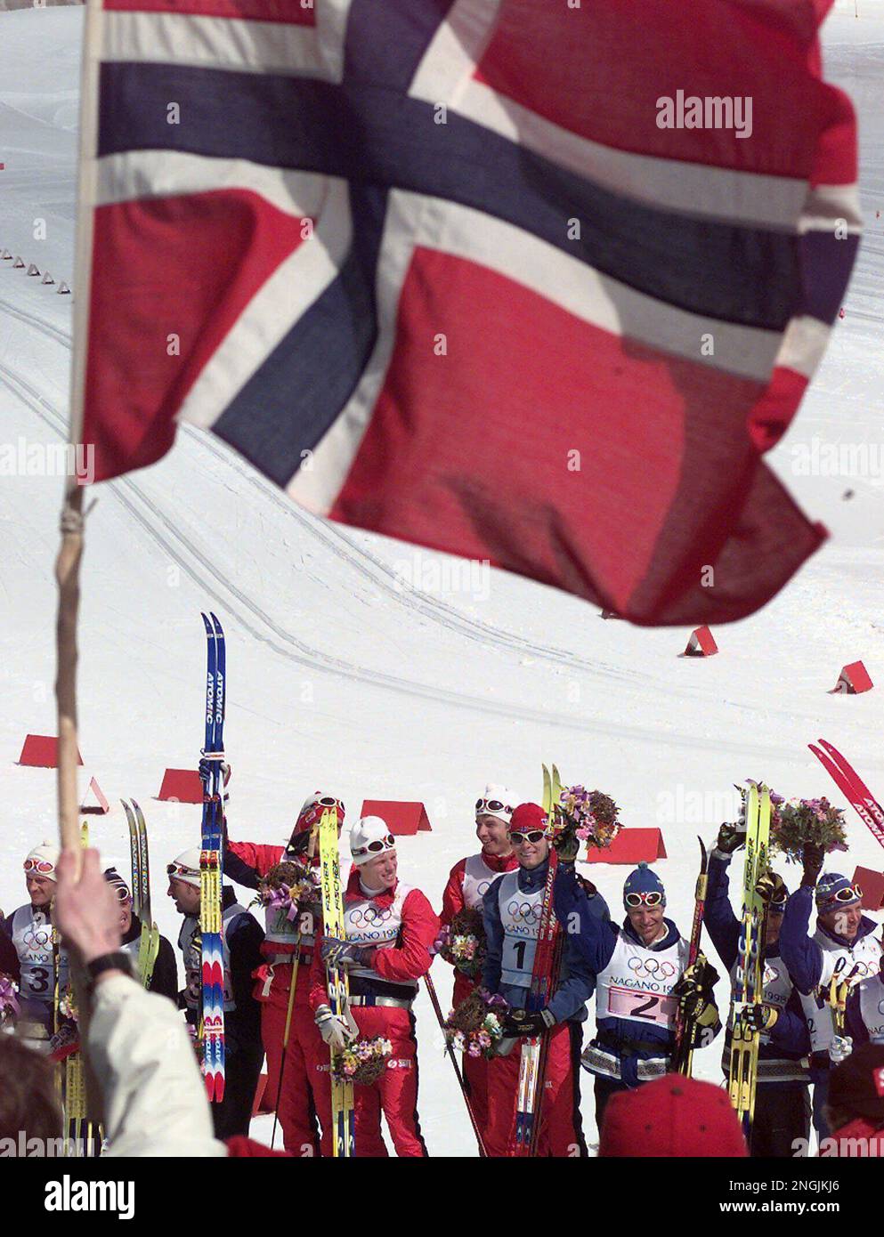 Norway's flag flies over gold medal winners Thomas Alsgaard, center in ...