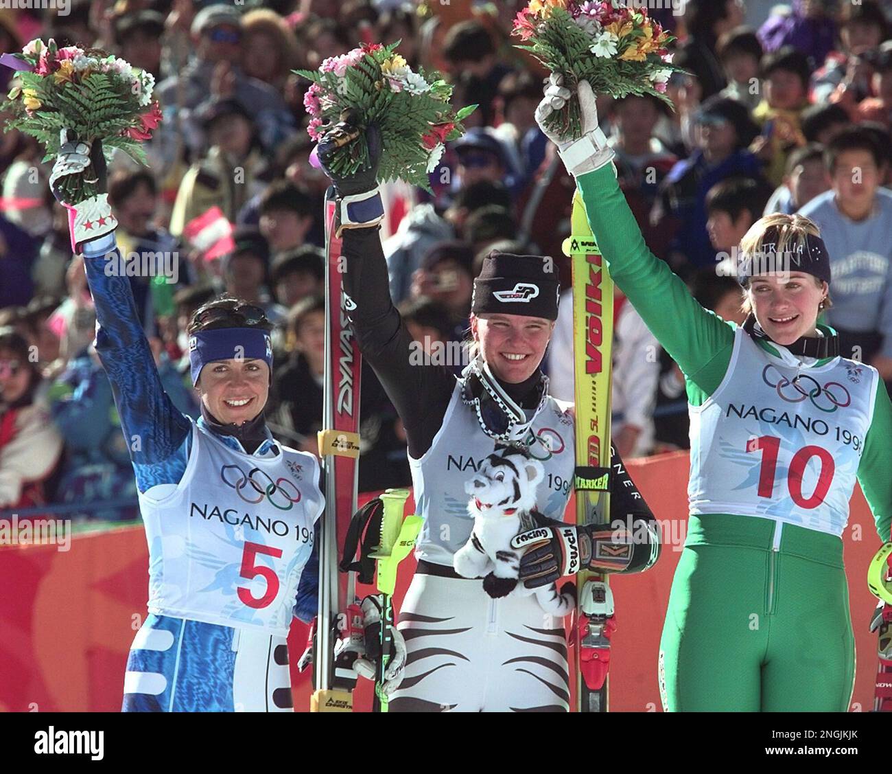 Olympic gold medal winner Hilde Gerg, of Germany, center, stands with ...