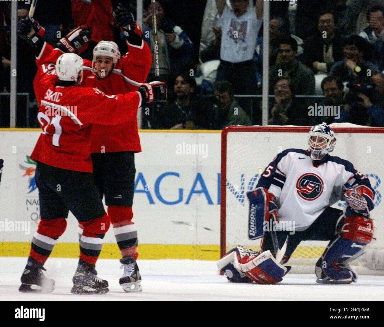Team Canada's Joe Sakic (91) celebrates with teammate Rob Zamuner as U ...