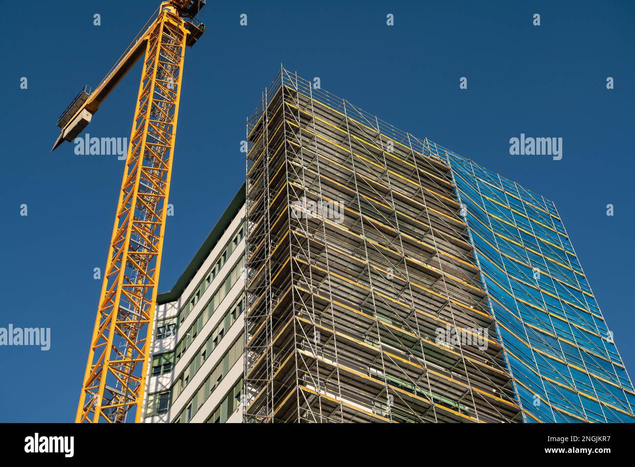 the scaffolding in a construction site with crane, the realization ...
