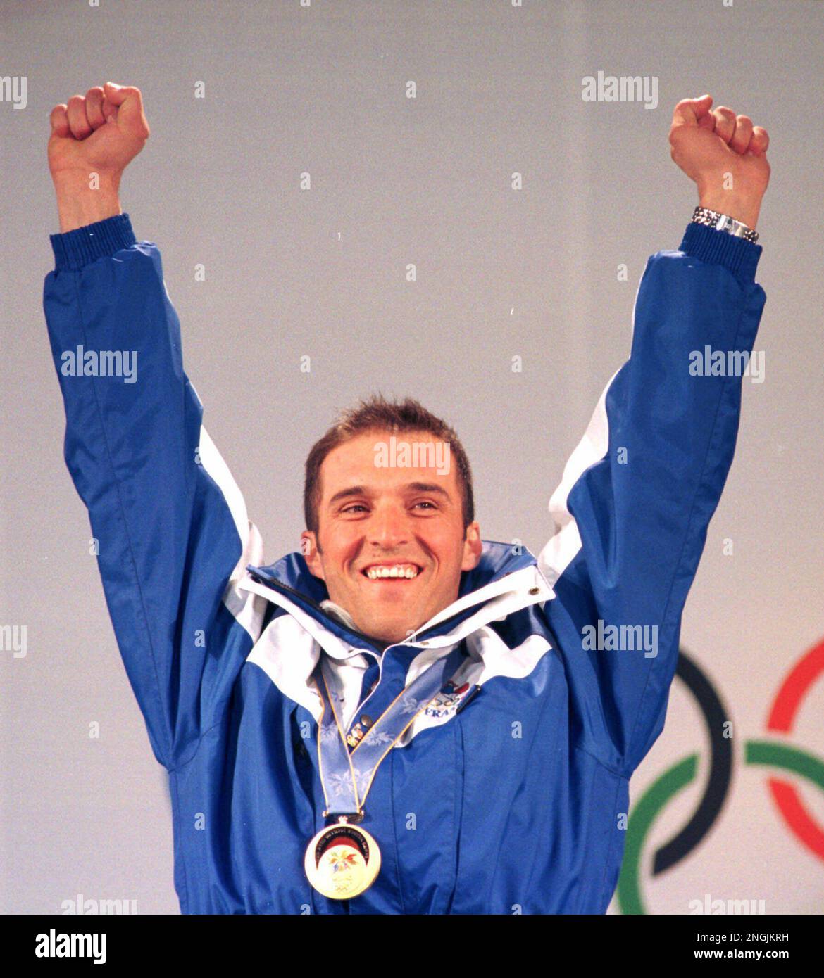 Gold medalist Jean-Luc Cretier, of France, holds up his arms after he ...