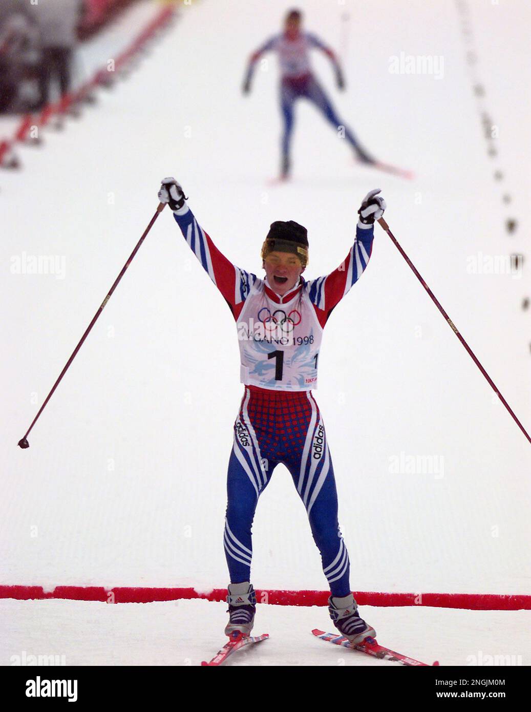 Russia's Larissa Lazutina celebrates as she crosses the finish line to ...