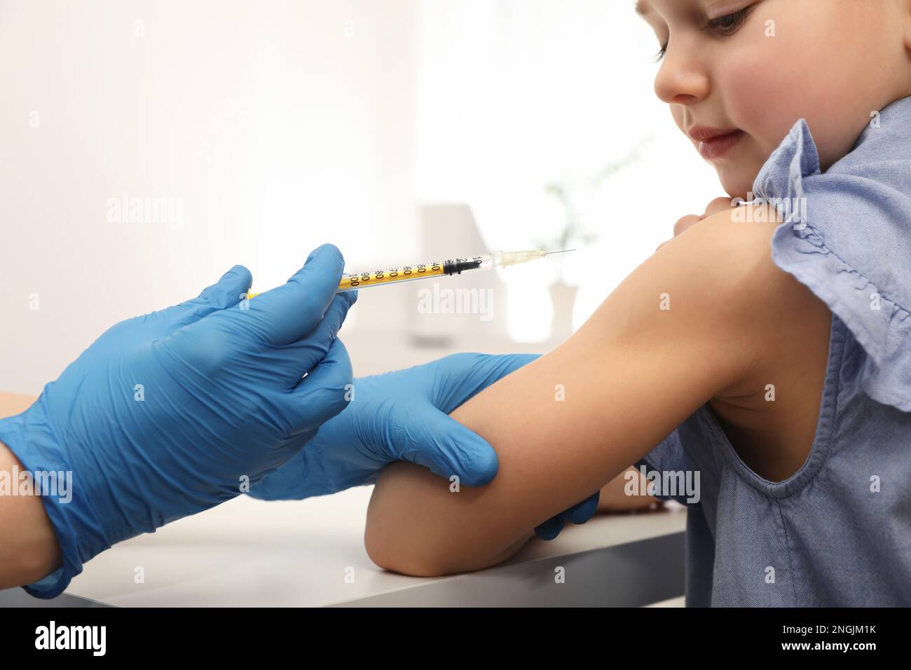 Doctor giving injection to little girl in hospital. Immunization ...