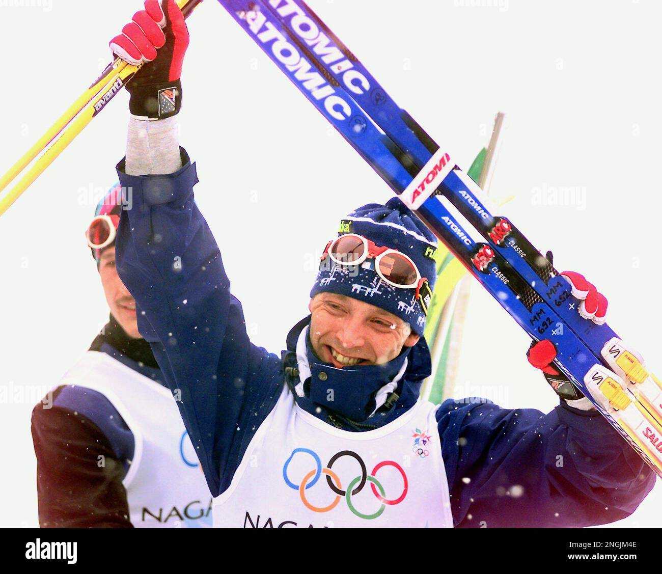 Finland's gold medal winner Mika Myllylae, center, celebrates his win ...