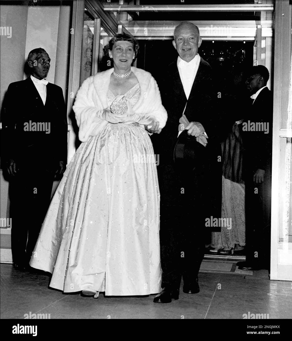 President Dwight Eisenhower holds the arm of his wife, first lady Mamie ...