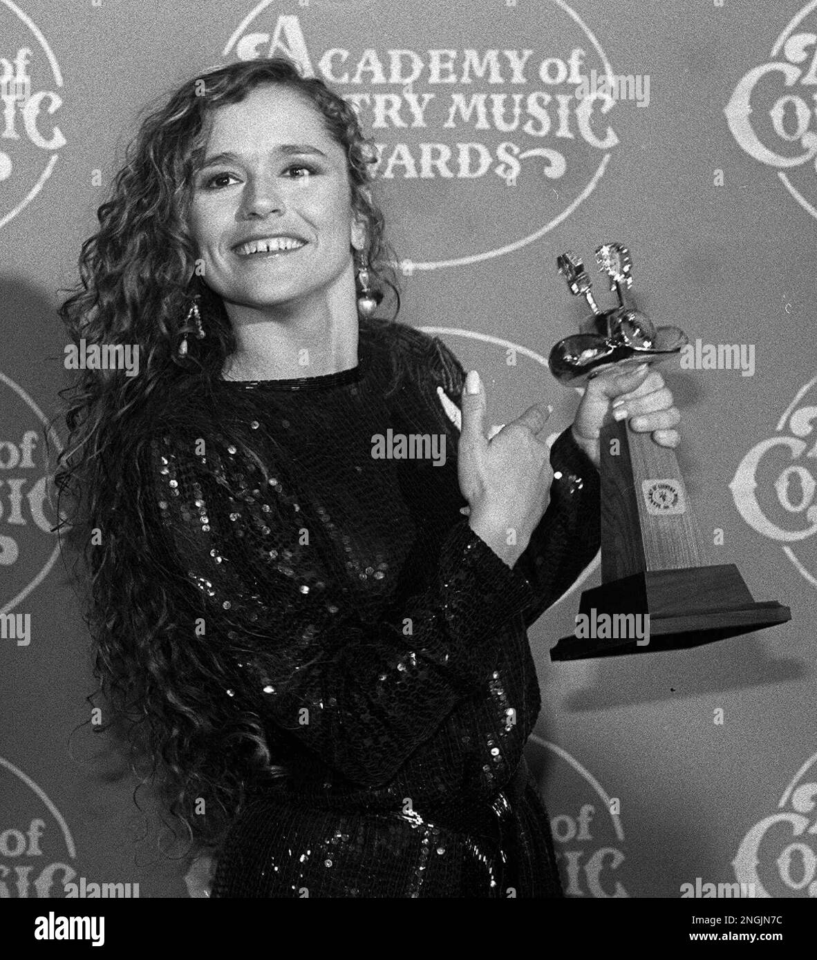 Nicolette Larson gestures to her "Hat" award during the Academy of ...