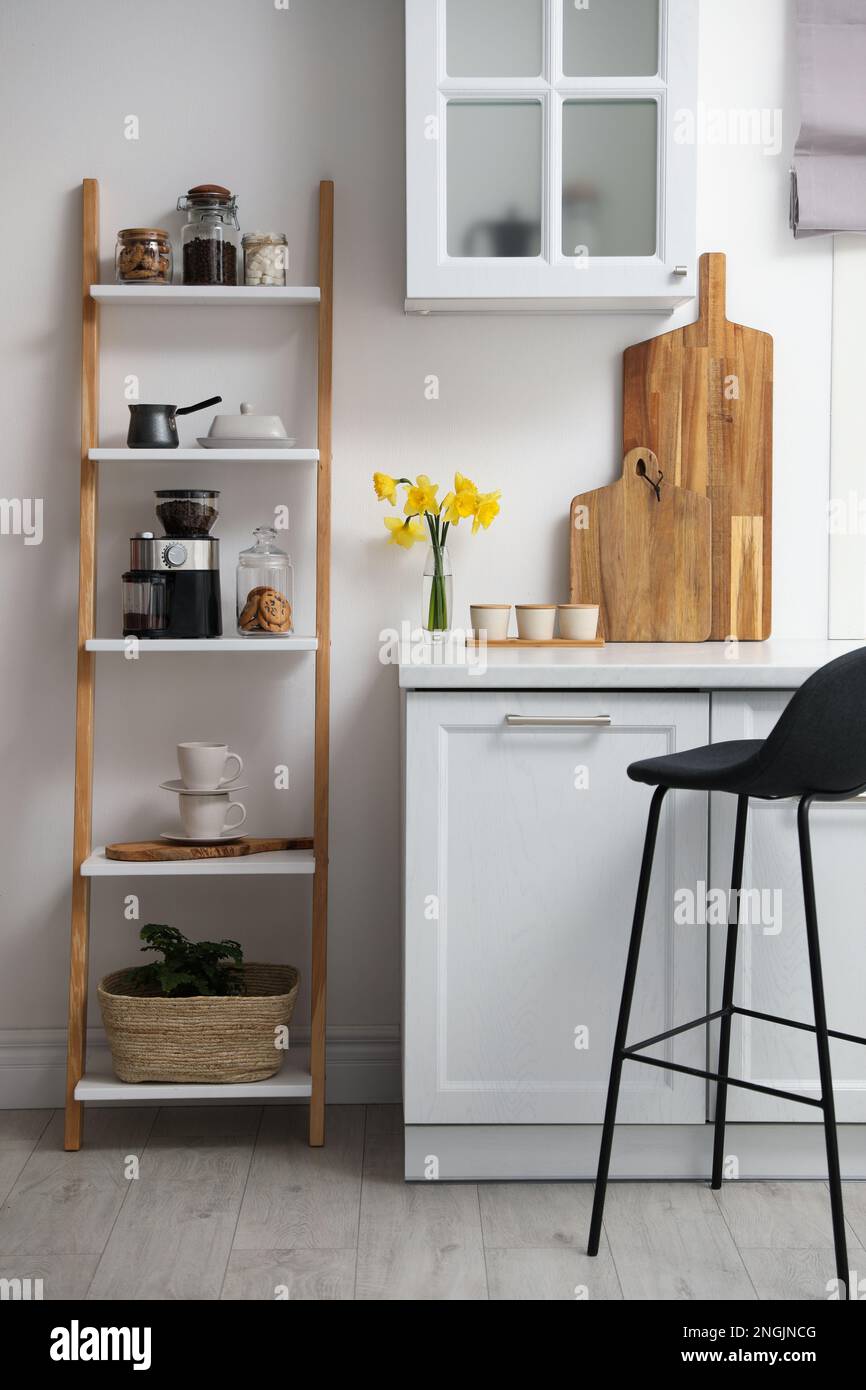 Modern coffee grinder on shelving unit in kitchen Stock Photo - Alamy
