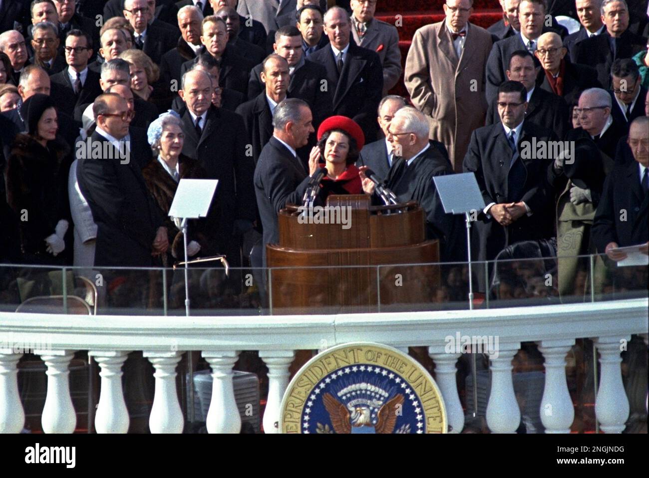 A distant view of Lyndon Johnson, shown taking the oath of office ...