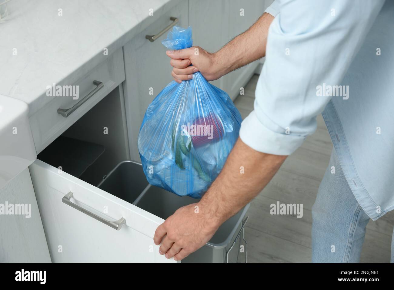 Man taking garbage bag out of bin at home, closeup Stock Photo - Alamy
