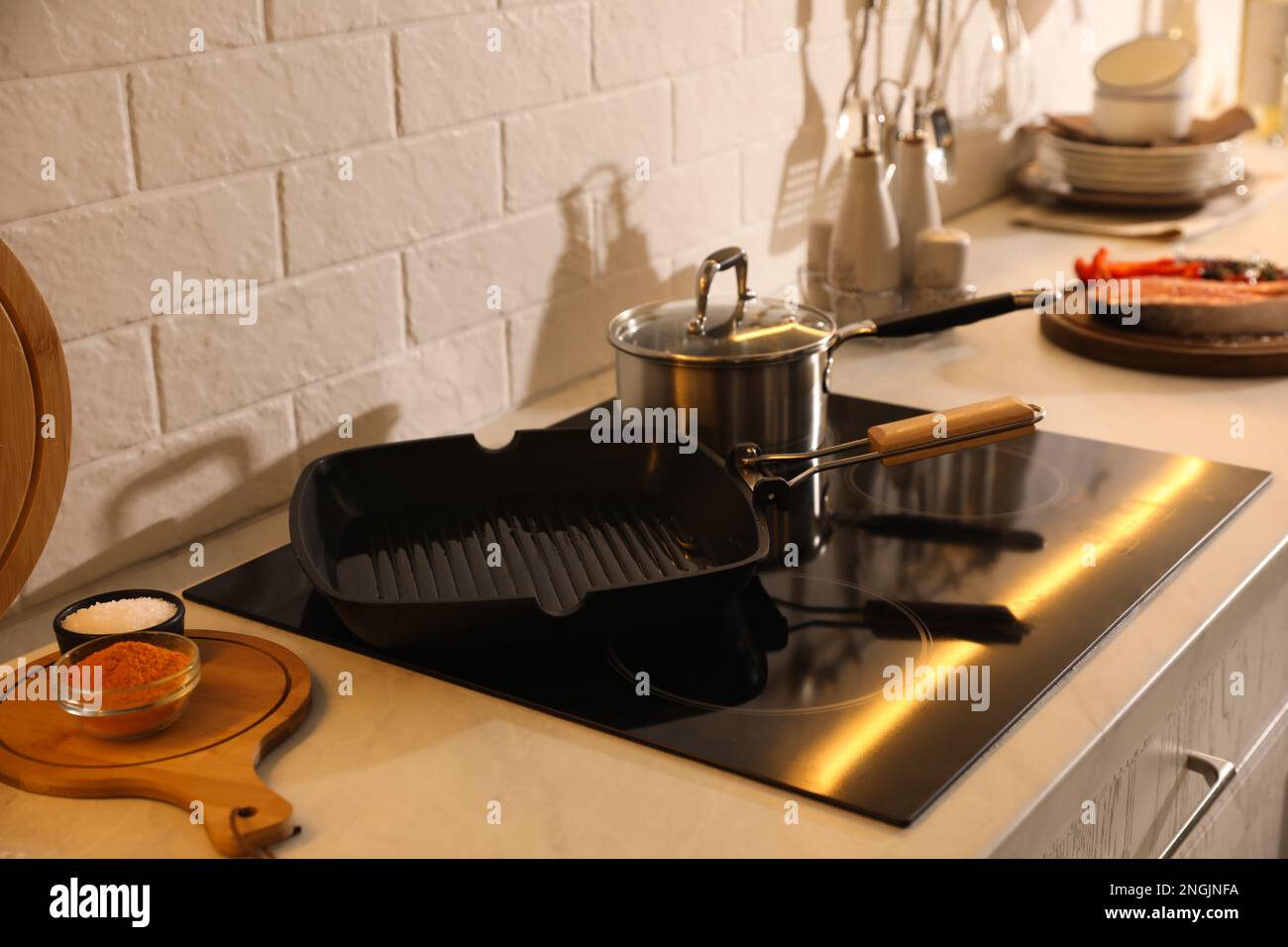 Frying pan with cooking oil on cooktop Stock Photo - Alamy