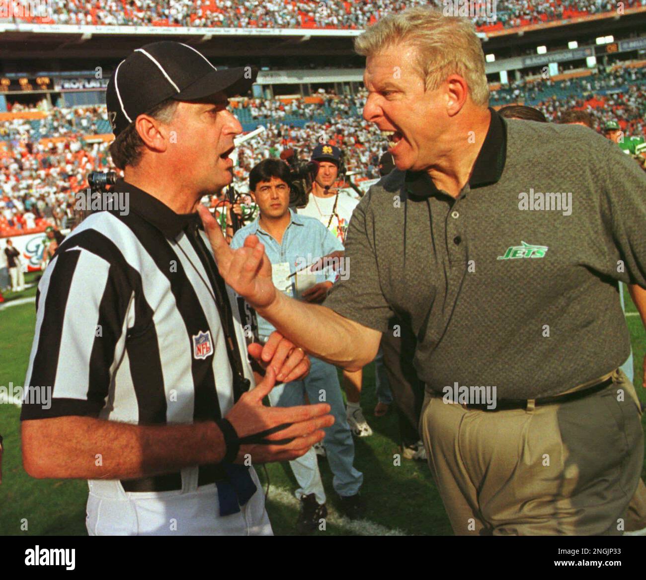 New York Jets head coach Bill Parcells complains to side judge Mike ...