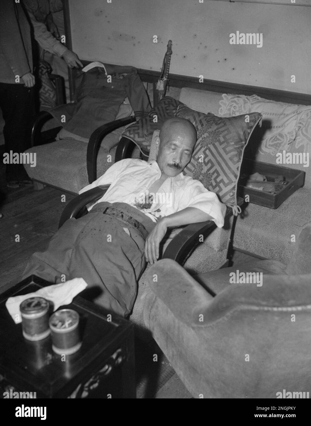 With a gaping bullet wound just below the heart, Gen. Hideki Tojo ...
