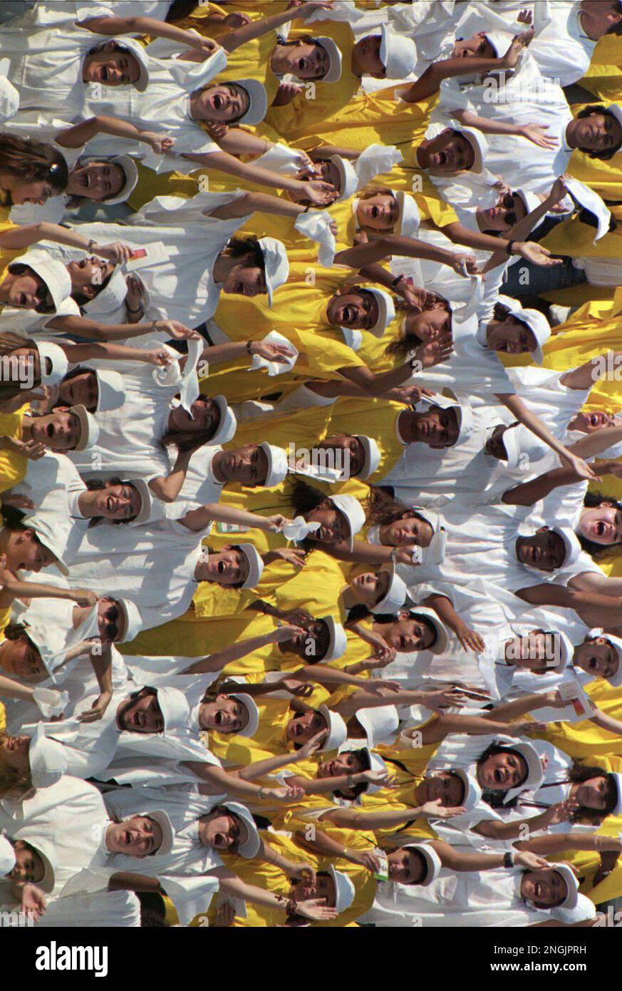 Faithfuls, wearing the colors of the Vatican, cheer Pope John Paul II ...
