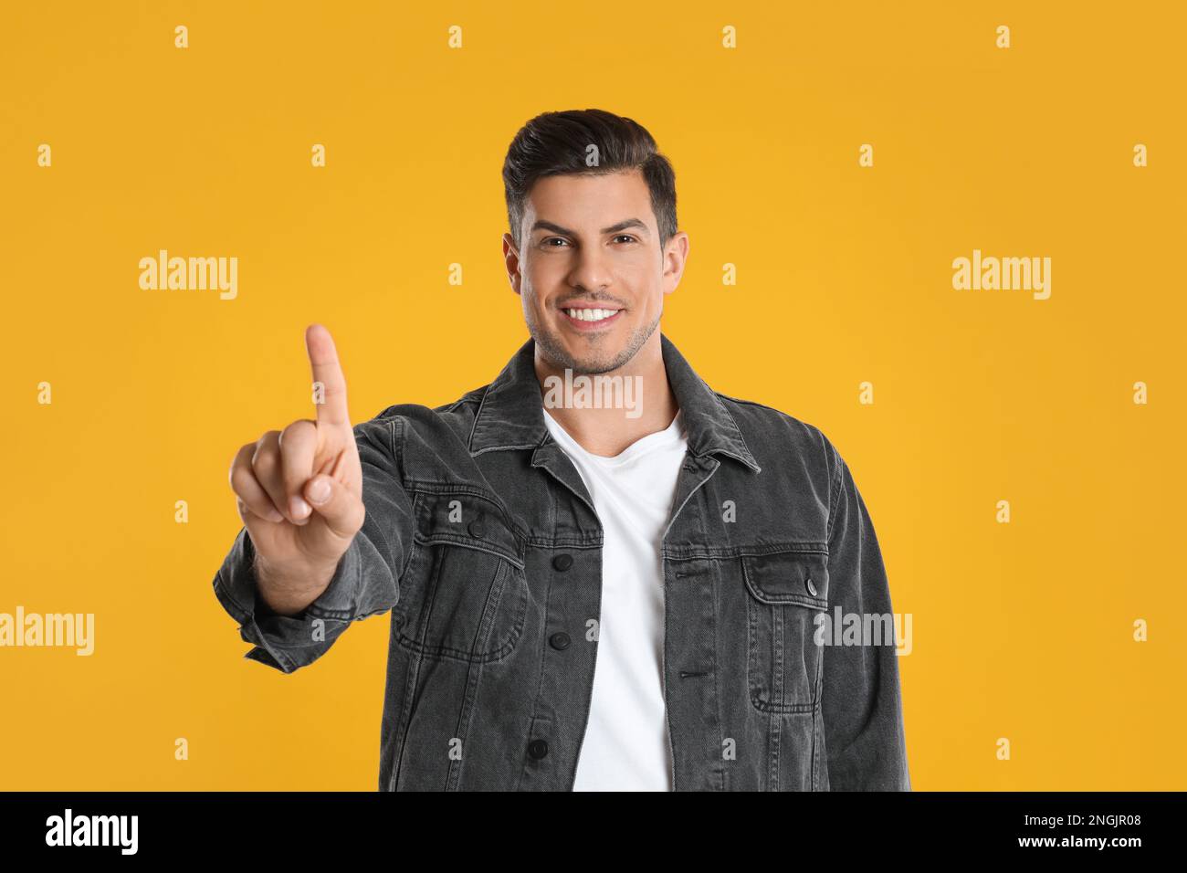 Man showing number one with his hand on yellow background Stock Photo ...
